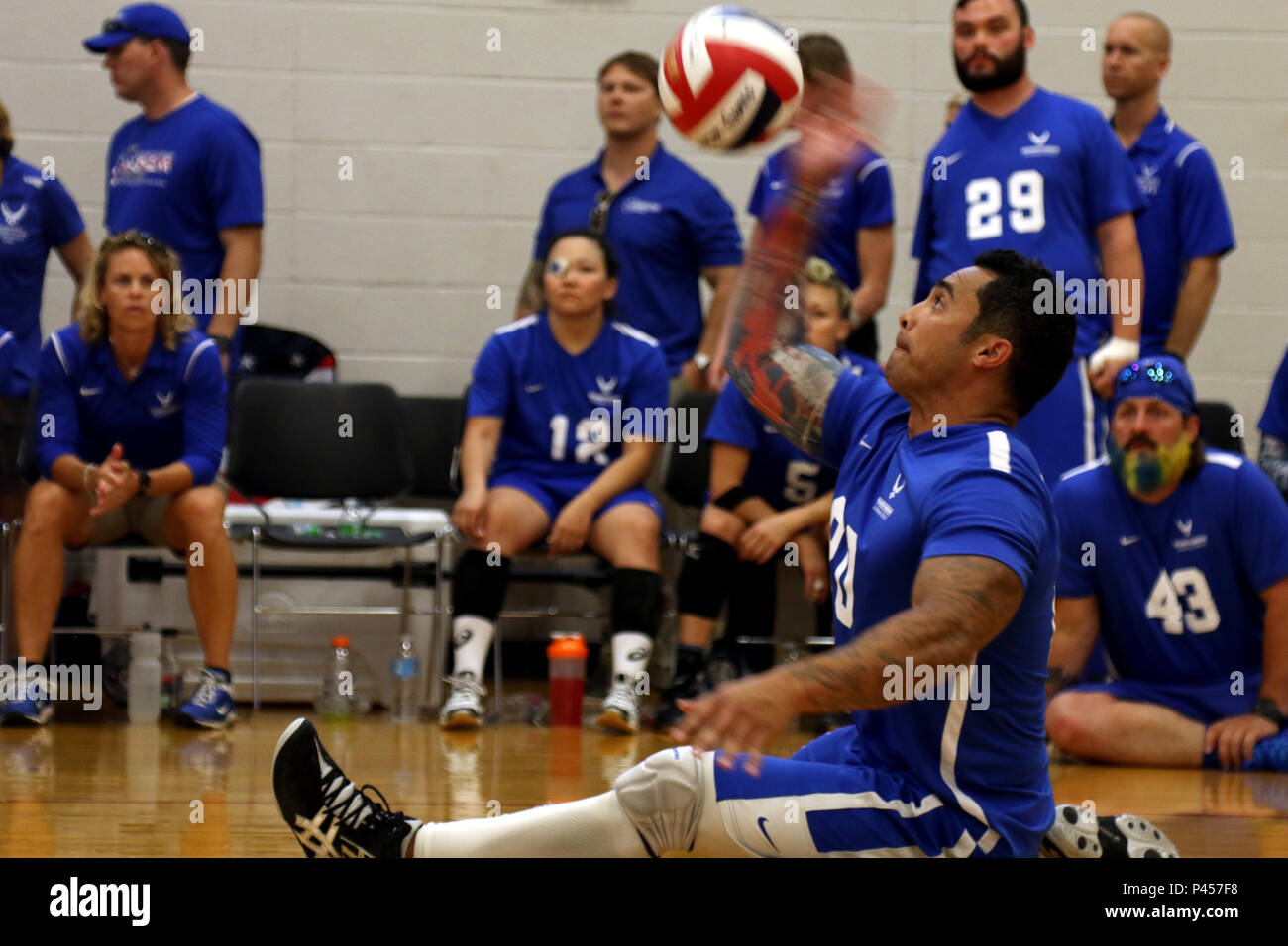 Air Force Veteran Christopher Ferrell prepares to serve during a sitting volleyball match at the ...