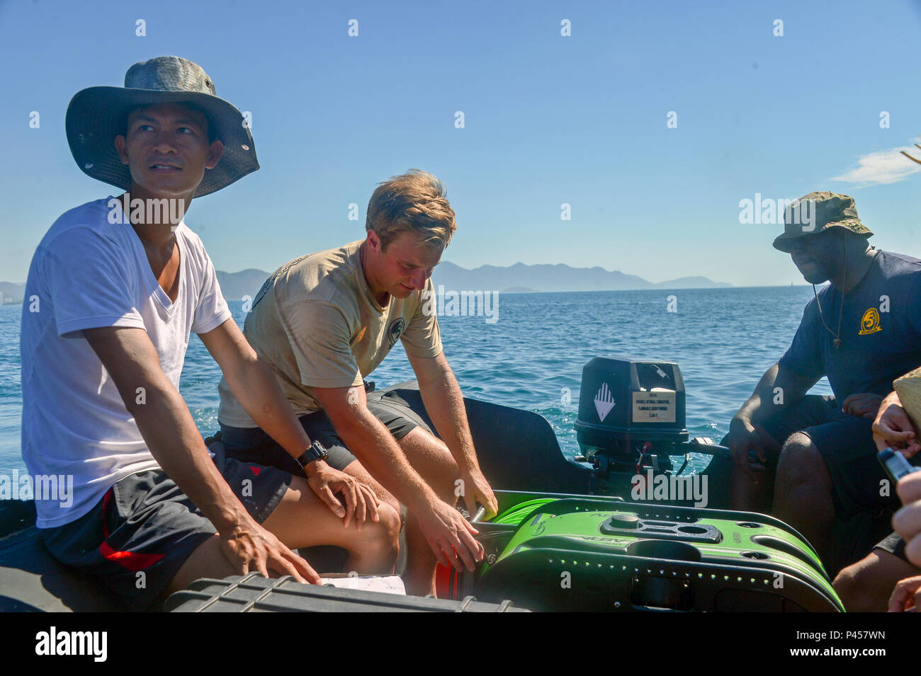 A U.S. Navy Lt. (middle), assigned to Explosive Ordnance Disposal ...