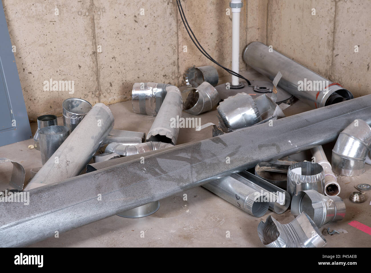 Duct pipe in dusty basement waiting for installation Stock Photo - Alamy