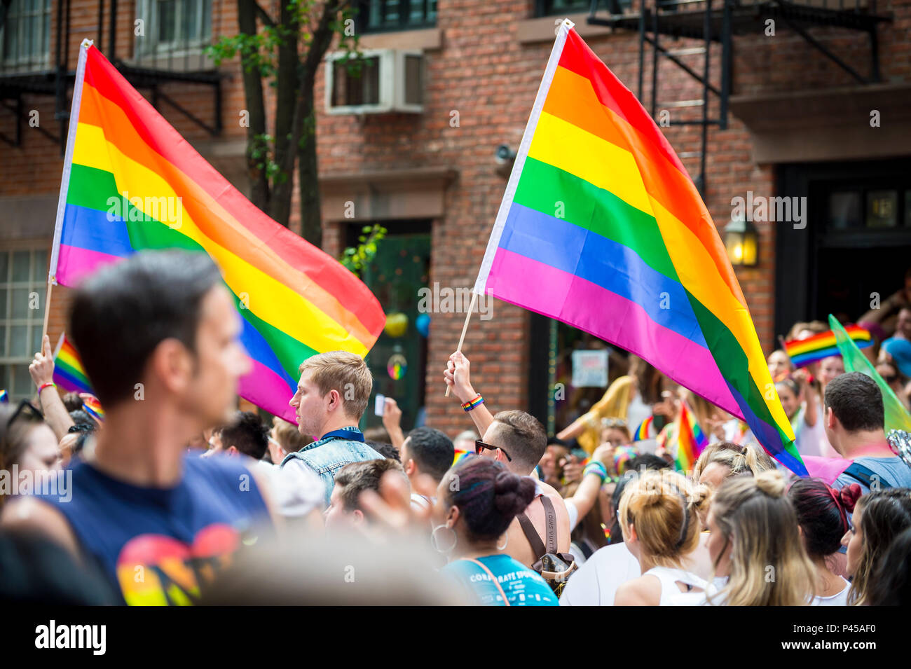 NEW YORK CITY - JUNE 25, 2017: Participants wave rainbow flag and ...