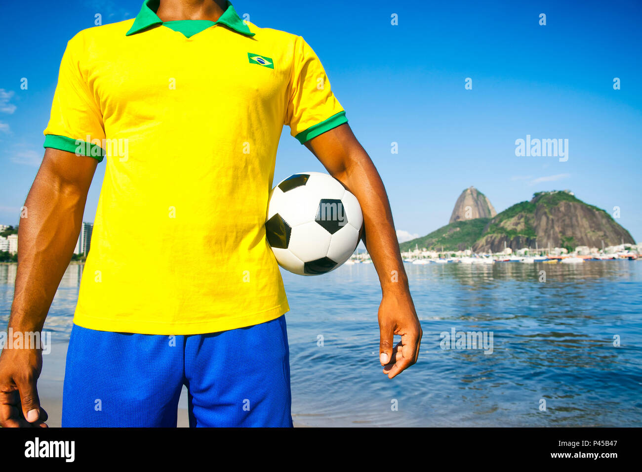 Soccer player holding football wearing shirt in Brazil flag colors at ...