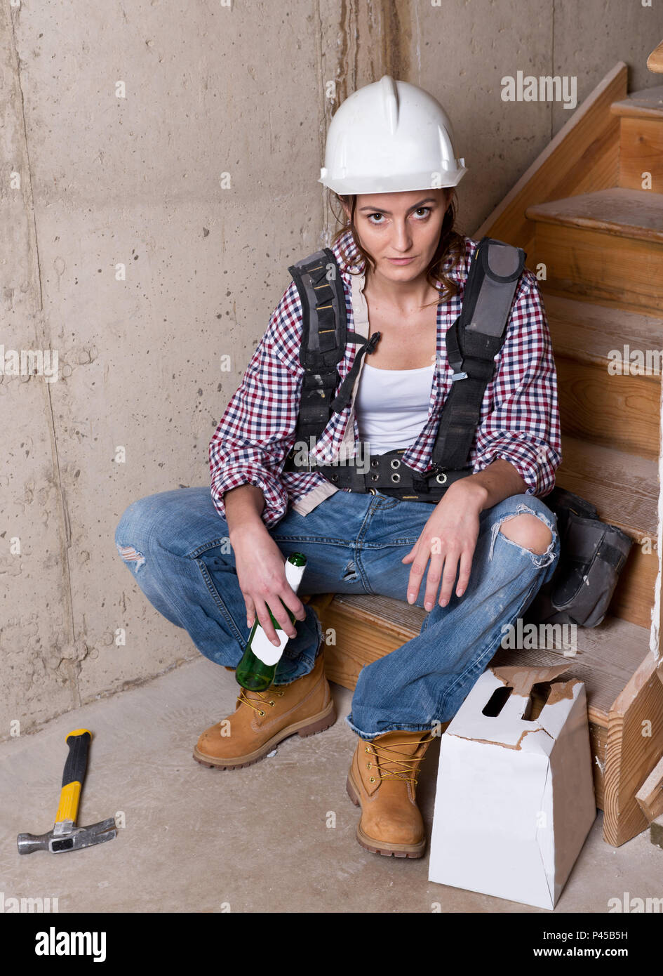 Female construction worker drinking beer after hard work day Stock ...