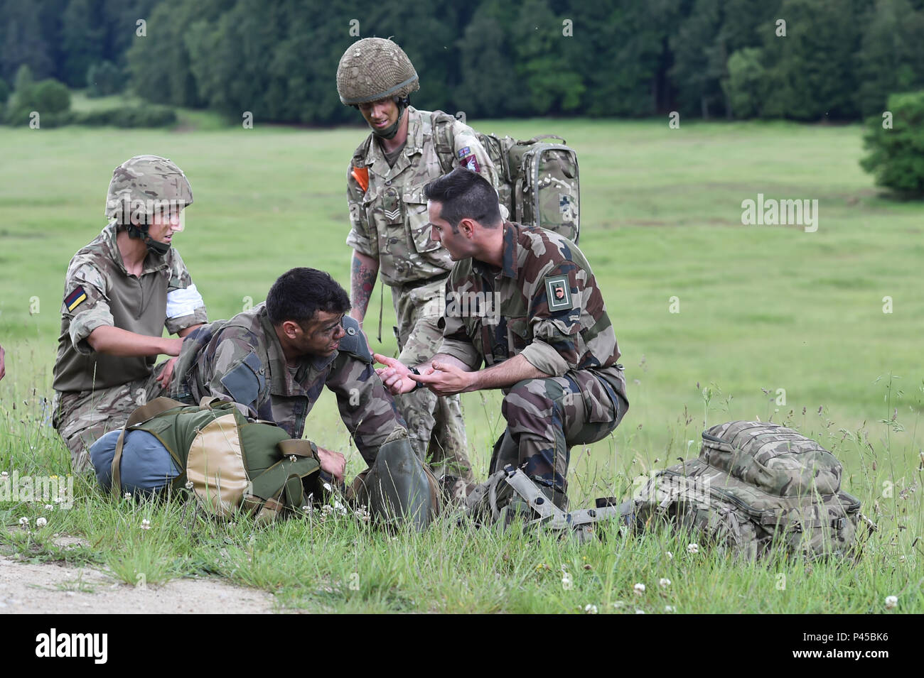 British Army medics take care of a French Army paratrooper during an ...
