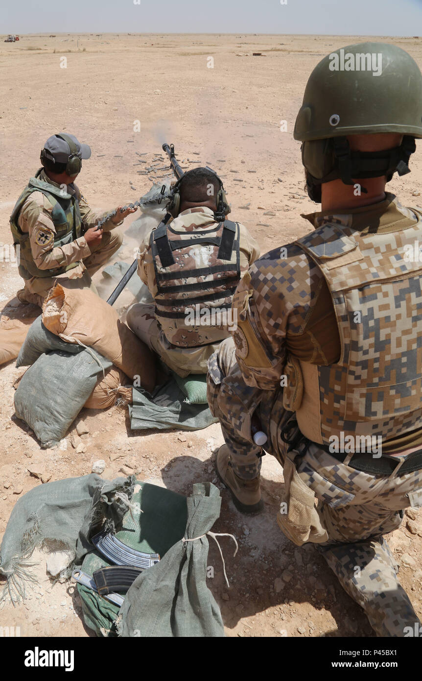 A Latvian soldier observes an Iraqi soldier assigned to the 2nd Anbar ...