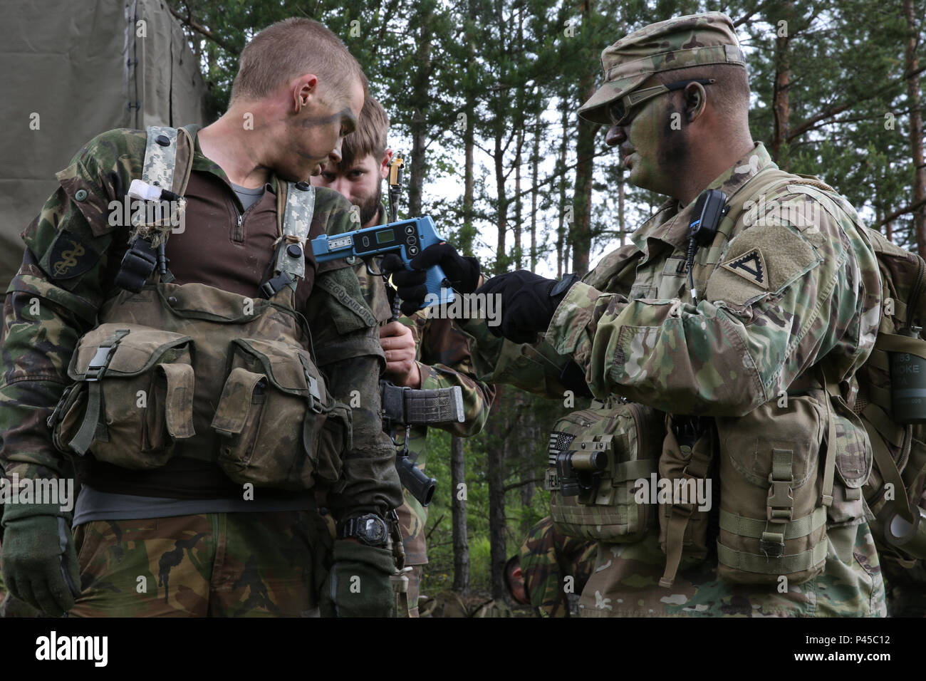A U.S. Soldier, right, of Timberwolf Team, Joint Multinational ...