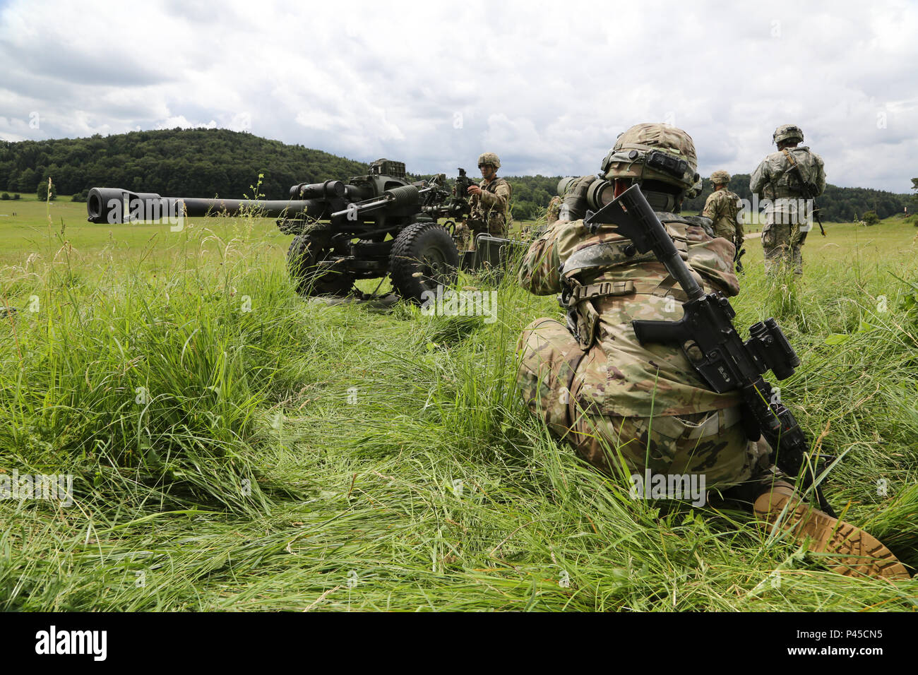 U.S. Soldiers of the 3rd Battalion, 319th Airborne Field Artillery Regiment calibrate a M119A3 ...