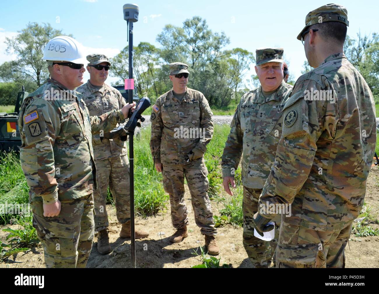 (From left to right) Spc. Riley Hughes, survey and design specialist ...