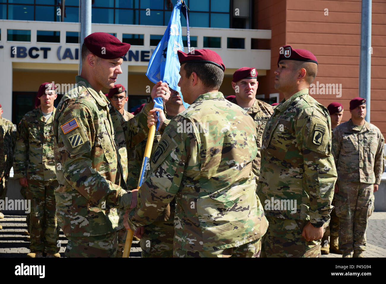 Capt. Daniel L. Enyart, Company D commander, left, receives the guidon ...