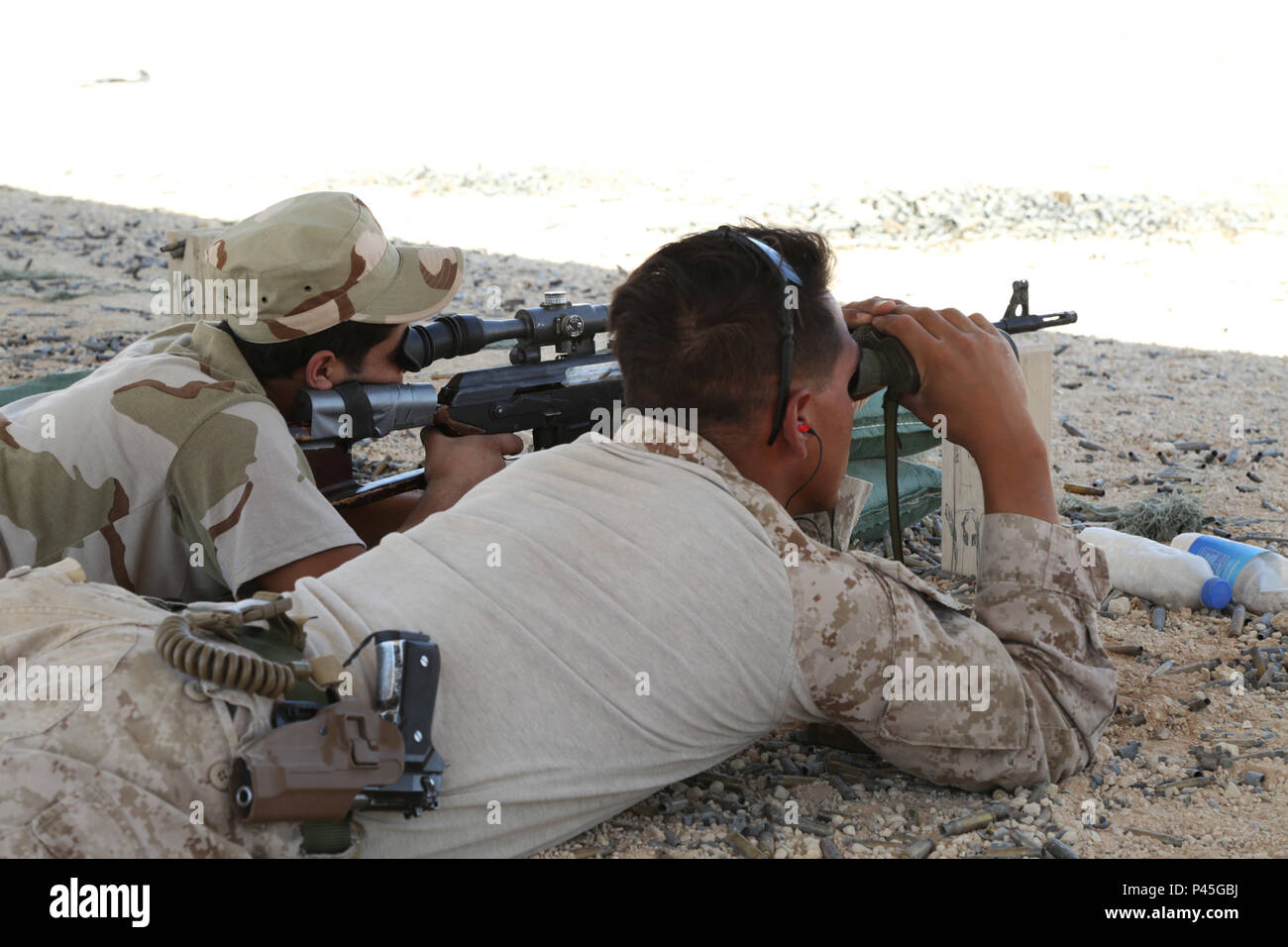 A U.S. Marine observes an Iraqi soldier assigned to the 29th Brigade ...