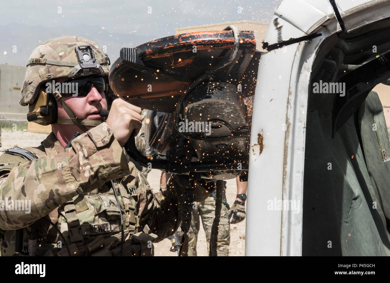 A U.S. Army soldier with Task Force Chosen, cuts the hood of a van ...