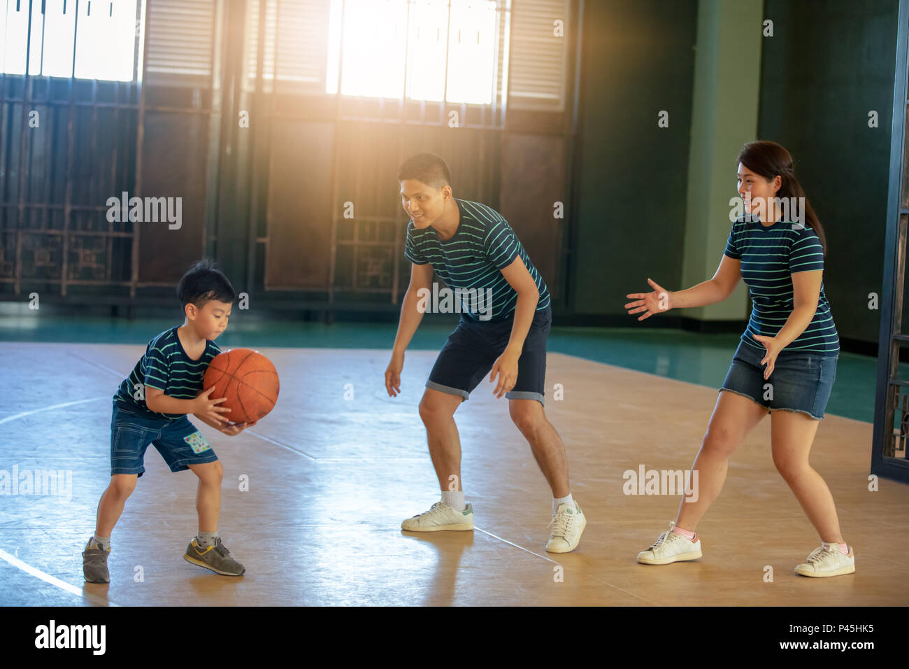 Asian family playing basketball together. Happy family spending free ...