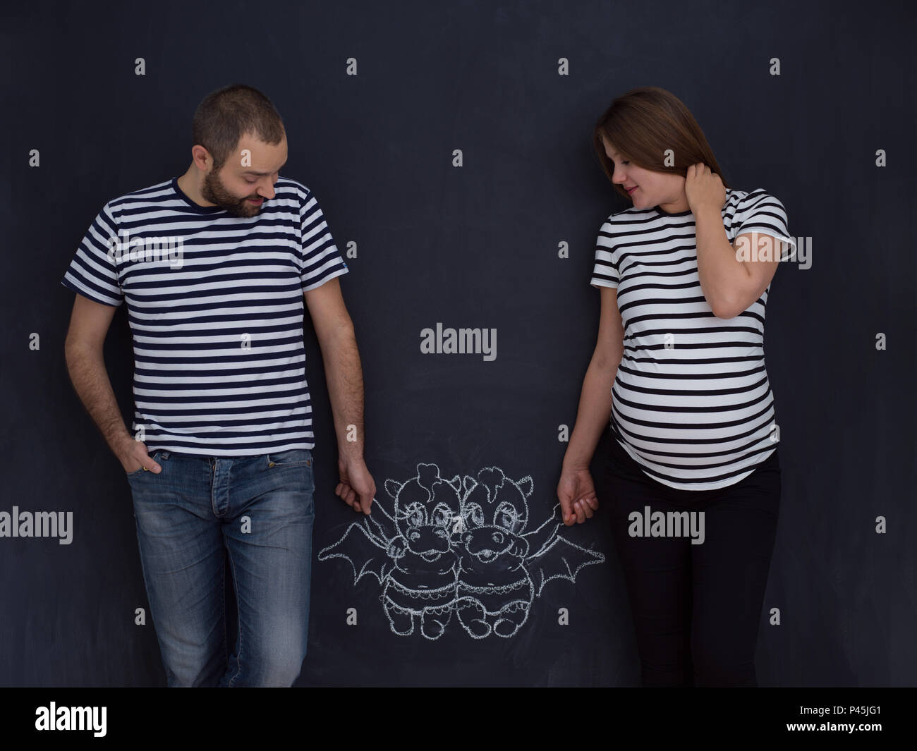 Conceptual photo of pregnant couple drawing their imaginations about ...