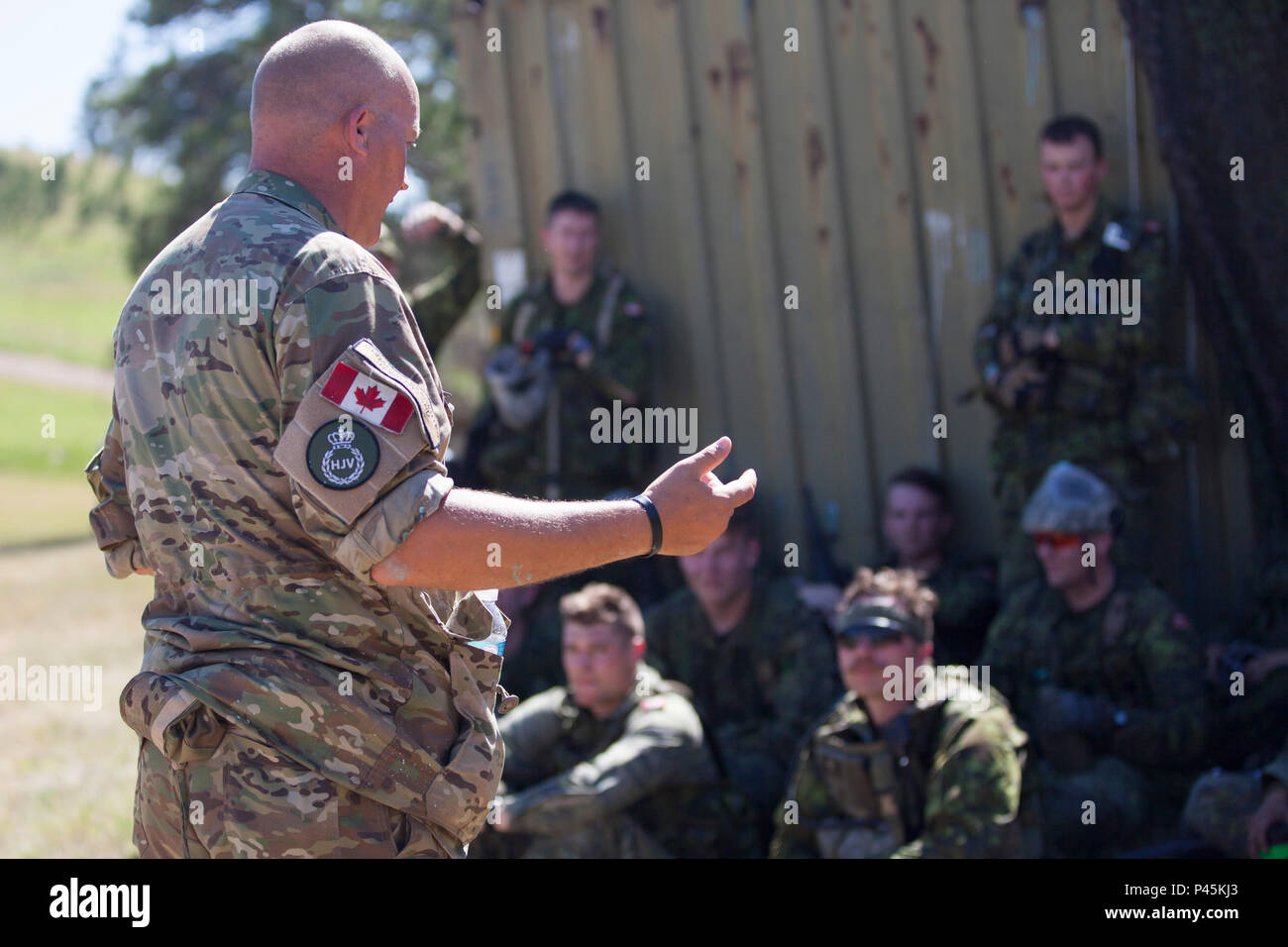 Danish Master Sgt. Claus Jorgen Peterson, conducts an after action ...