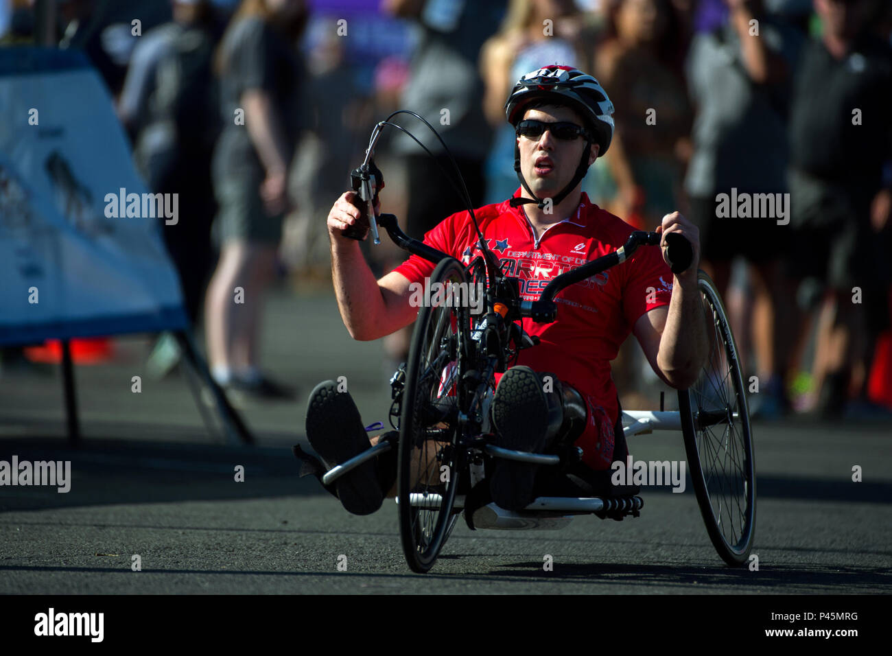 Marine Corps 2nd Lt. Anthony Kemp powers a hand cycle across the finish ...