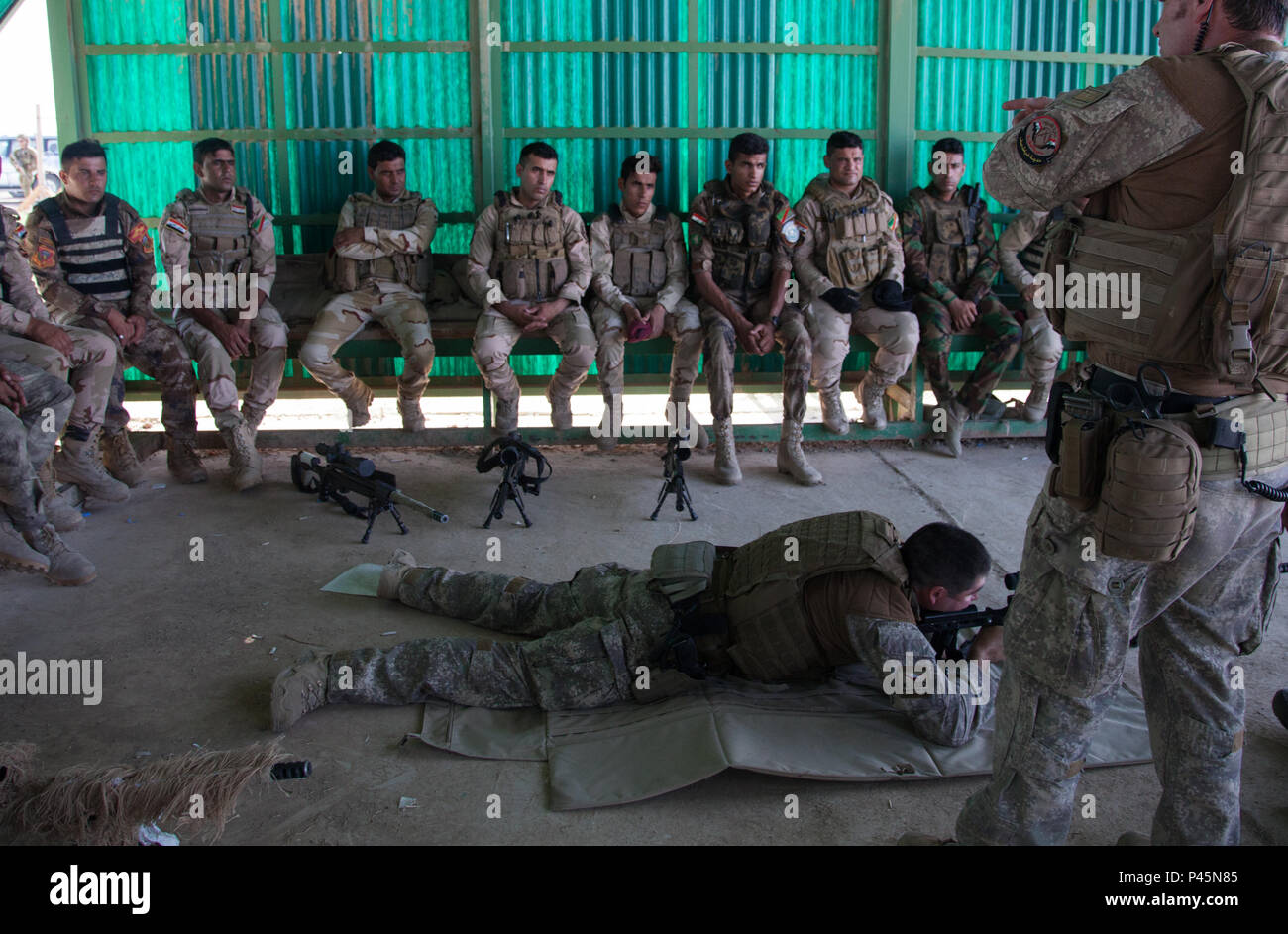 New Zealand soldiers teach a class on proper prone position with a ...
