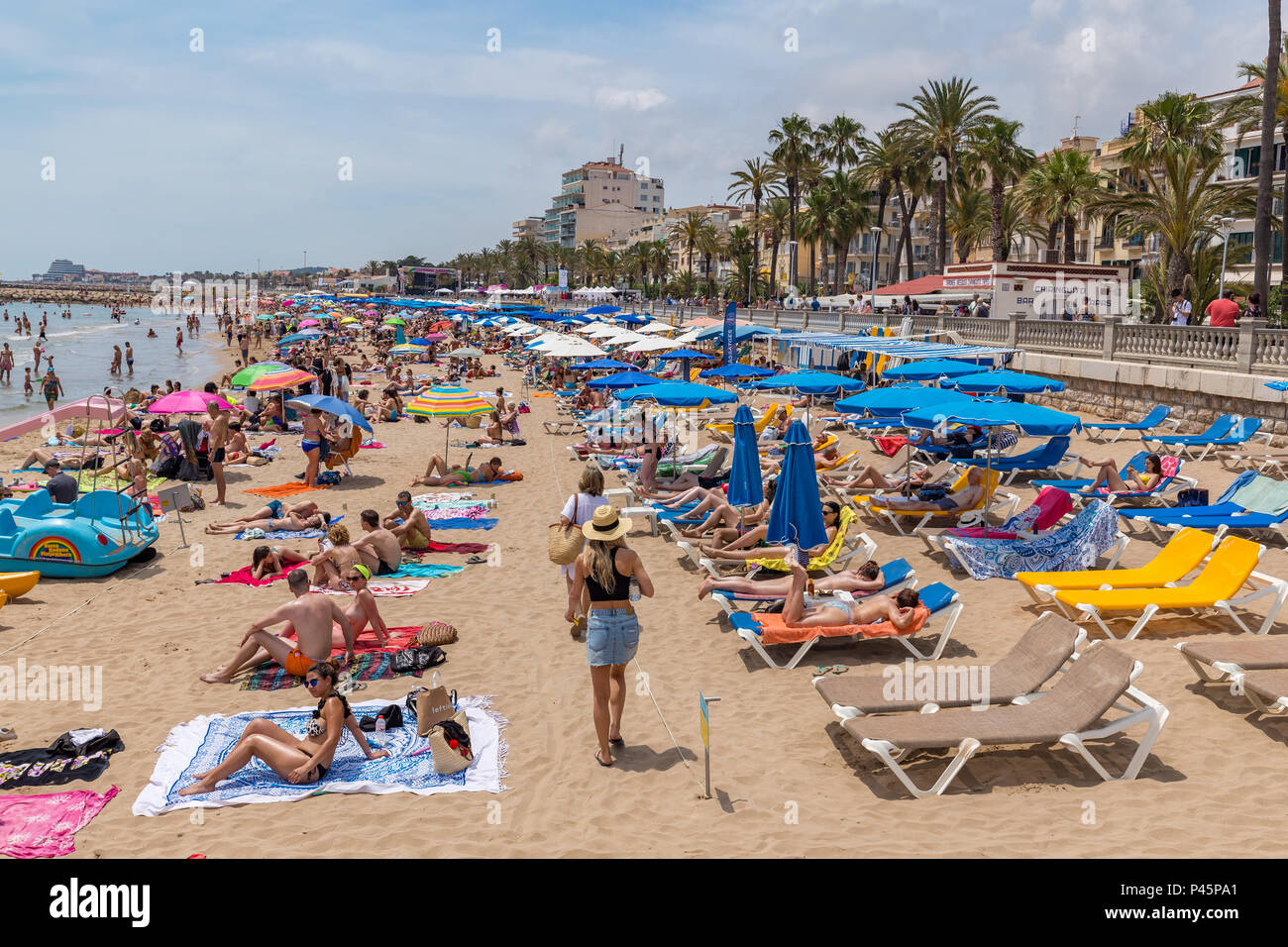 Sunny day on the beach in a small spanish village Sitges, 17. 06. 2018 ...