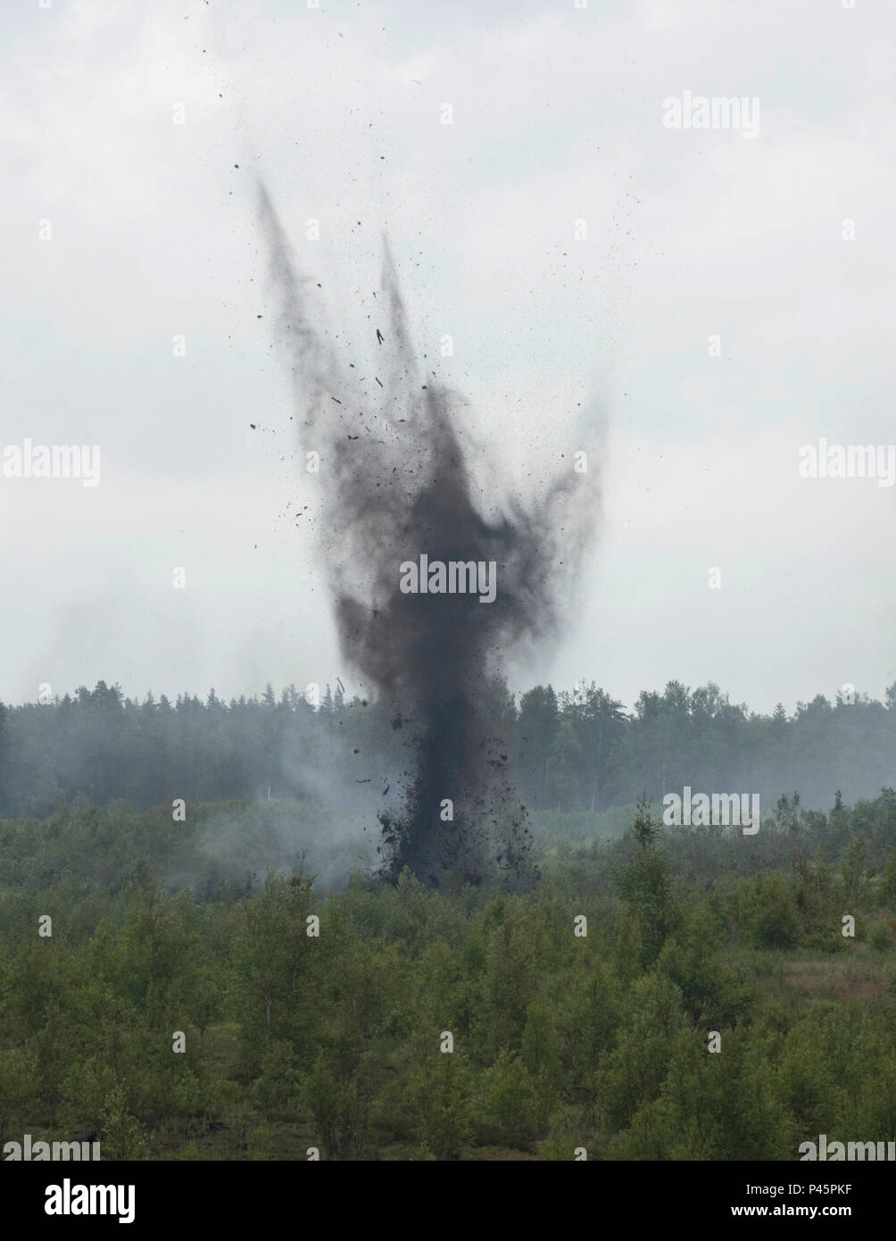 A 155 mm artillery shell explodes in the engagement area after being ...