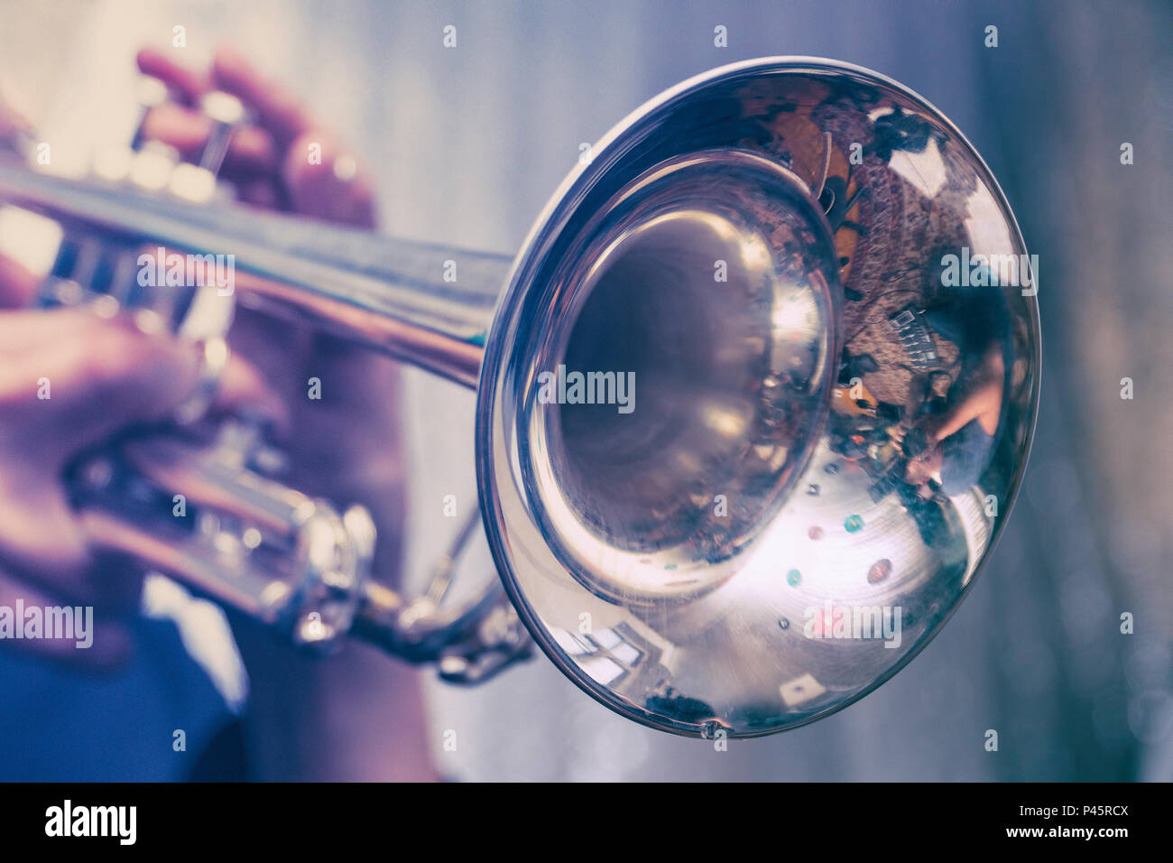 Trumpeter is playing on a silver trumpet Stock Photo - Alamy