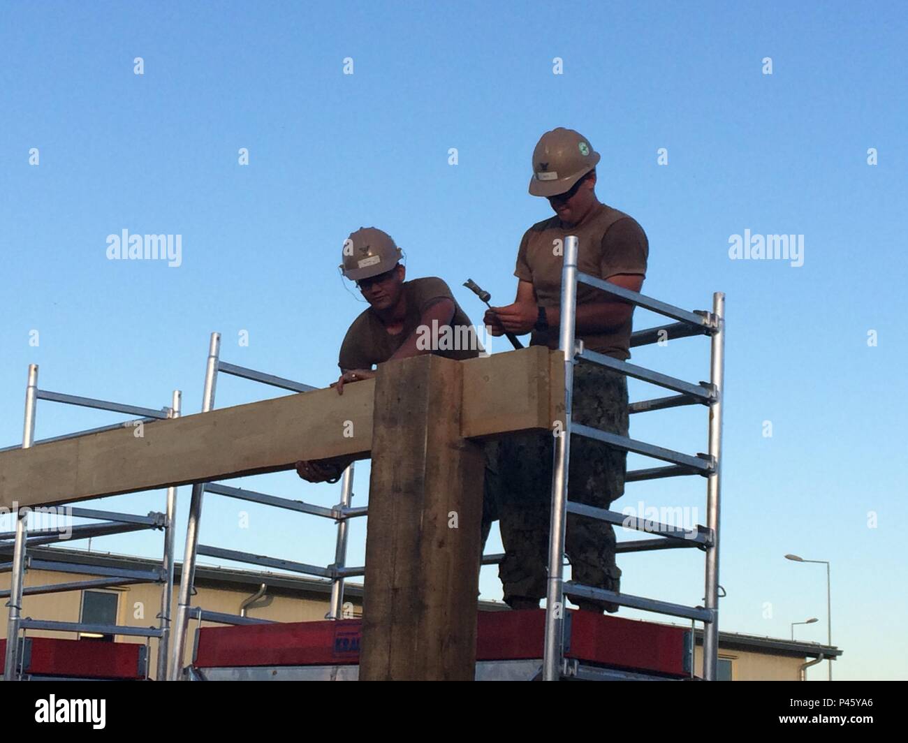 U.S. Navy Builder Third Class Stephen Alianell and Equipment Operator ...