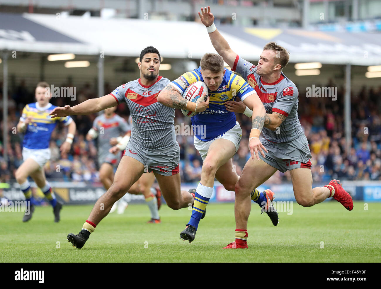 Leeds Rhinos Liam Sutcliffe holds off Catalans Dragons' Lewis Tierney ...