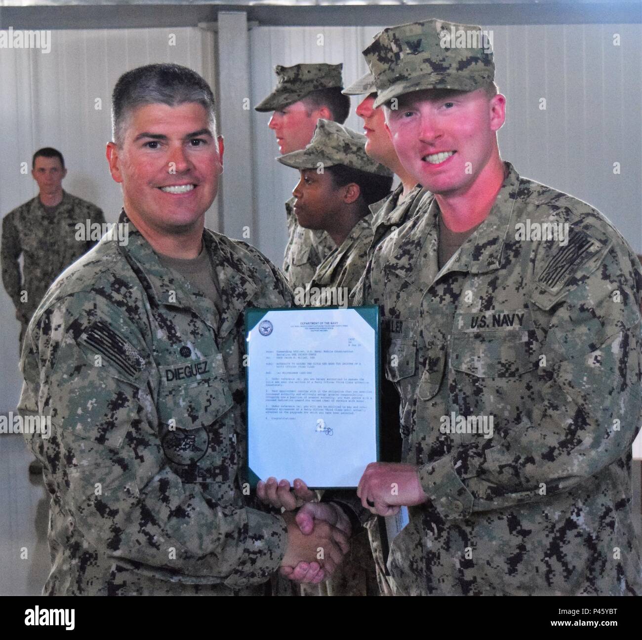 Constructionman Electrician Third Class Jacob Miller receives a ...