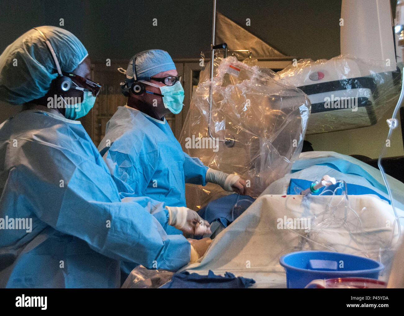 Maj. Ryan McDonough (background), chief of cardiology, William Beaumont ...