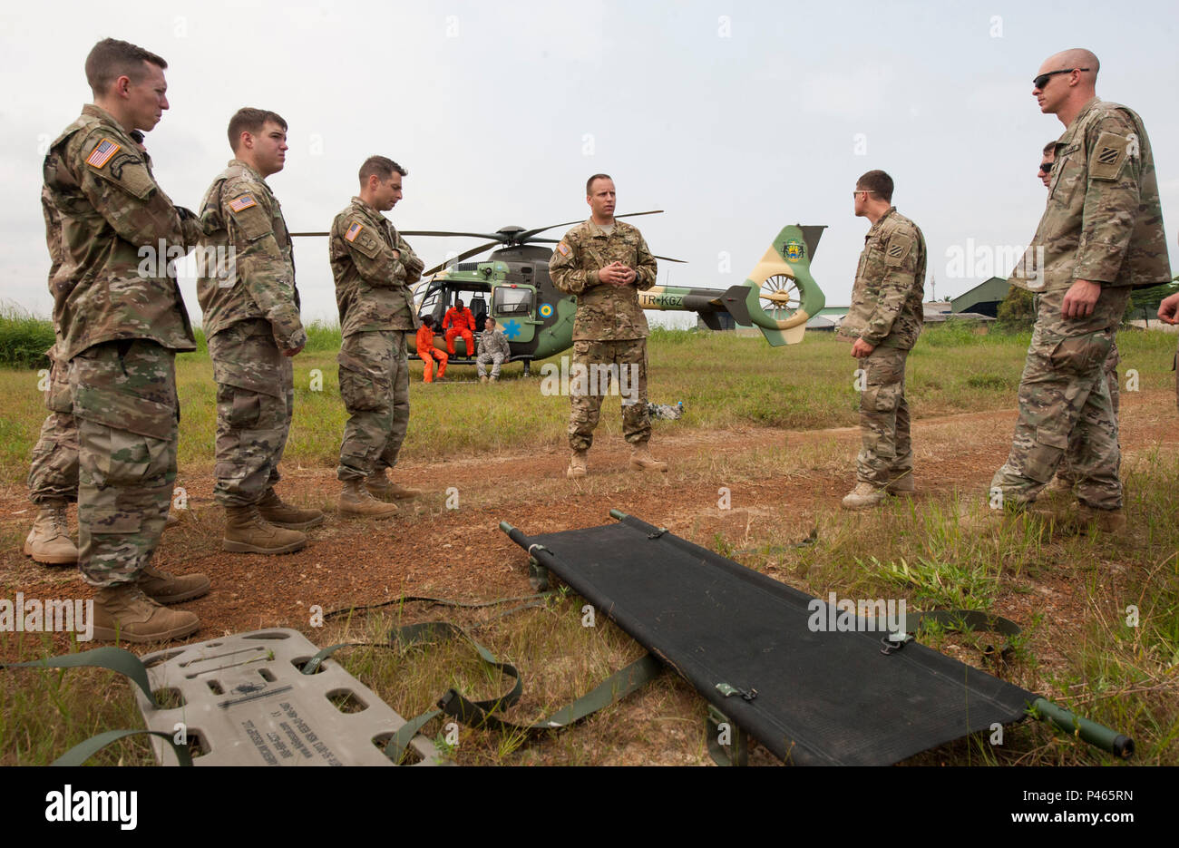 U.S. Army MAJ. Jeffrey Sills (center), an aeromedical evacuation ...