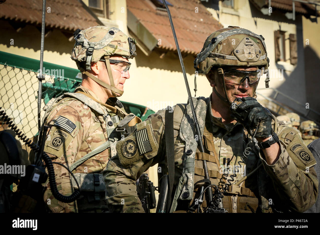 A Paratrooper uses his radio to communicate with his company during a ...