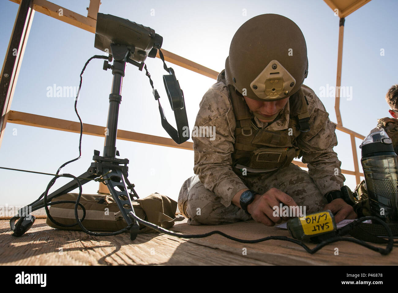 A Marine plots coordinates on a map using a defense advanced GPS ...