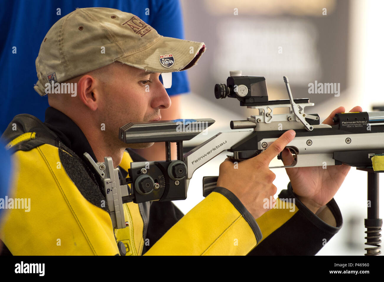 Army Capt. Justin Decker aims an air rifle during the shooting ...