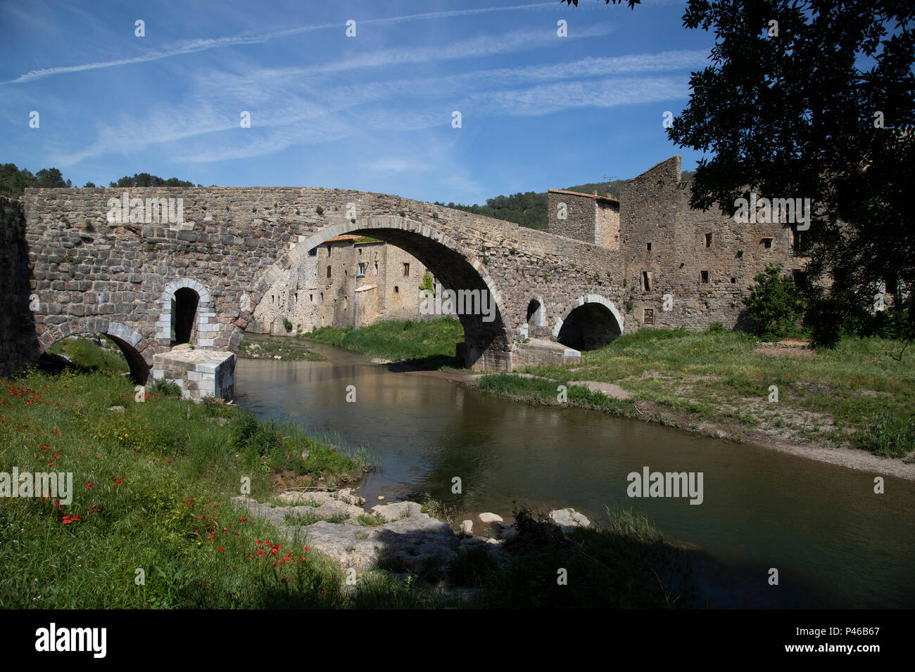 Scene of the stone bridge across the river in the medieval village of ...