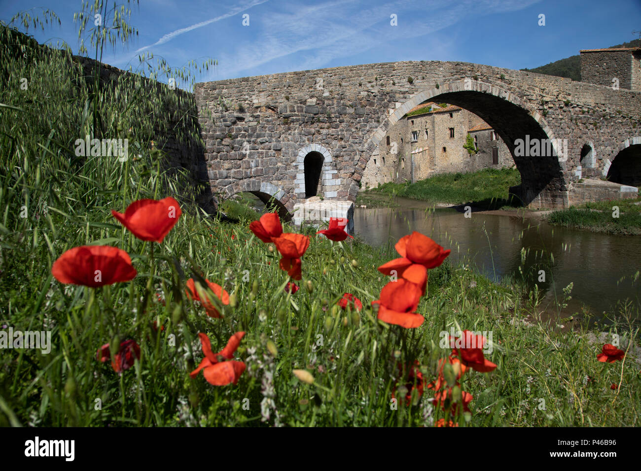Scene of the stone bridge across the river in the medieval village of ...