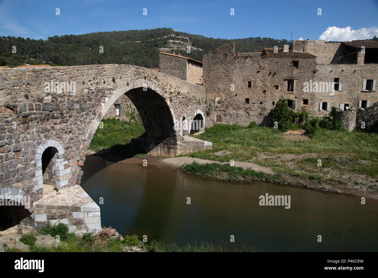Scene of the stone bridge across the river in the medieval village of ...