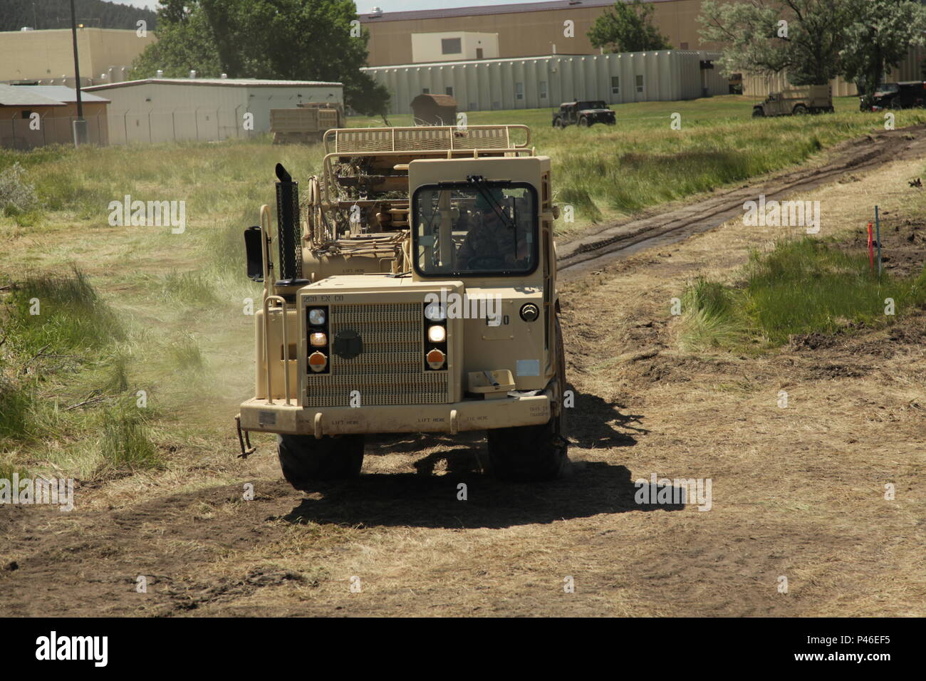 A U.S. Army 613C scraper is driven by Danish Pvt. Per Victor Sorensen ...