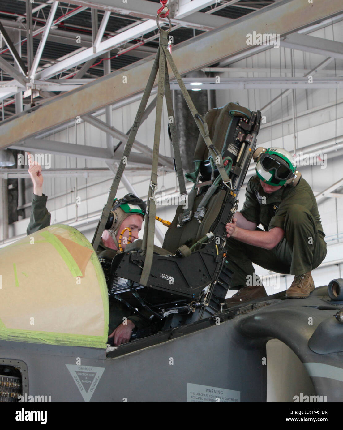 Staff Sgt. Michael McQuaig, left, and Cpl. Joseph Noble, removes an ...