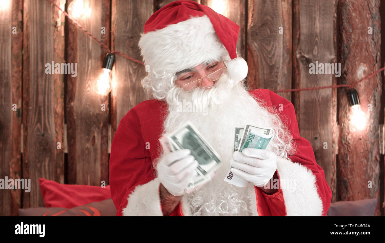 Santa Claus counting his money and showing money disappearing trick ...
