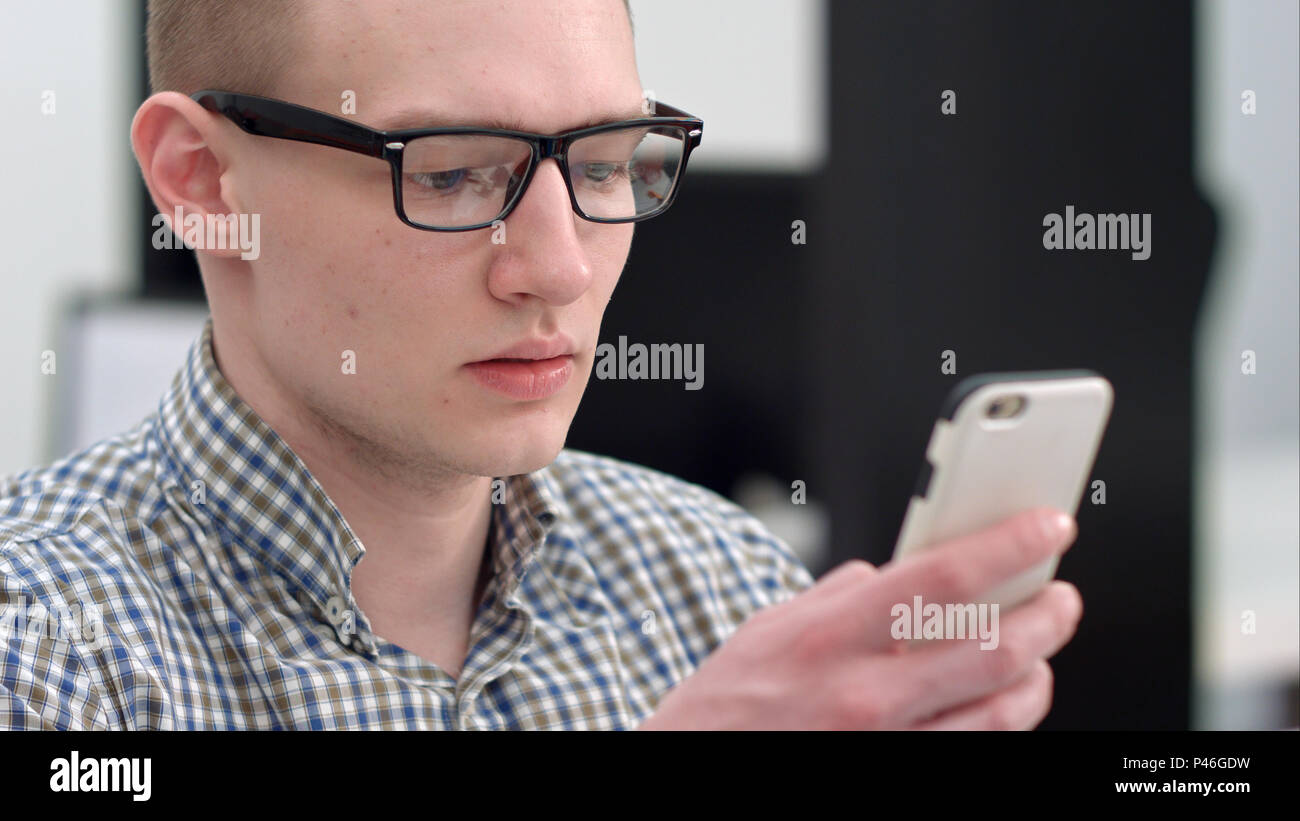 Serious office worker using mobile phone Stock Photo - Alamy