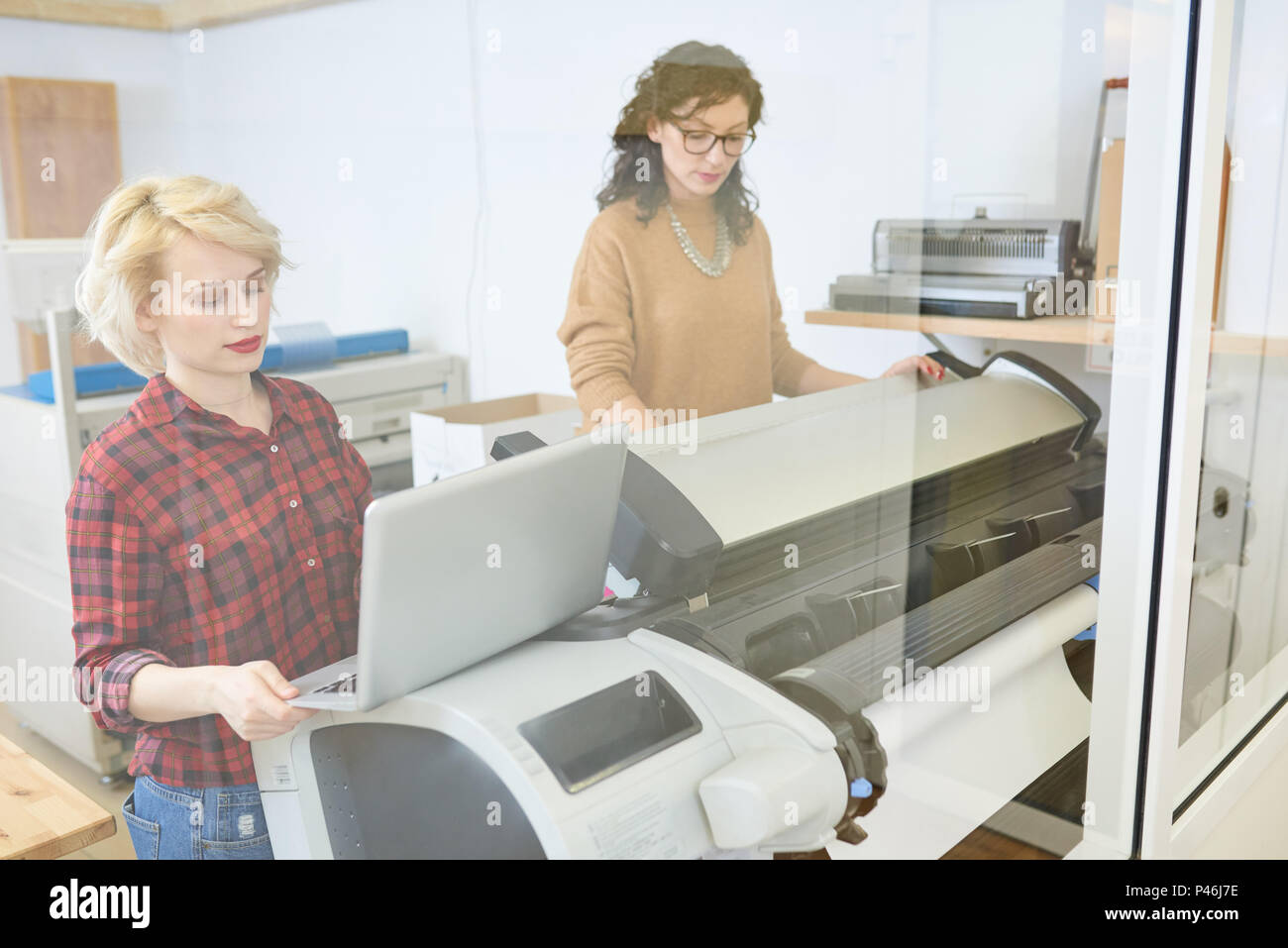 Printer operators working in office Stock Photo - Alamy