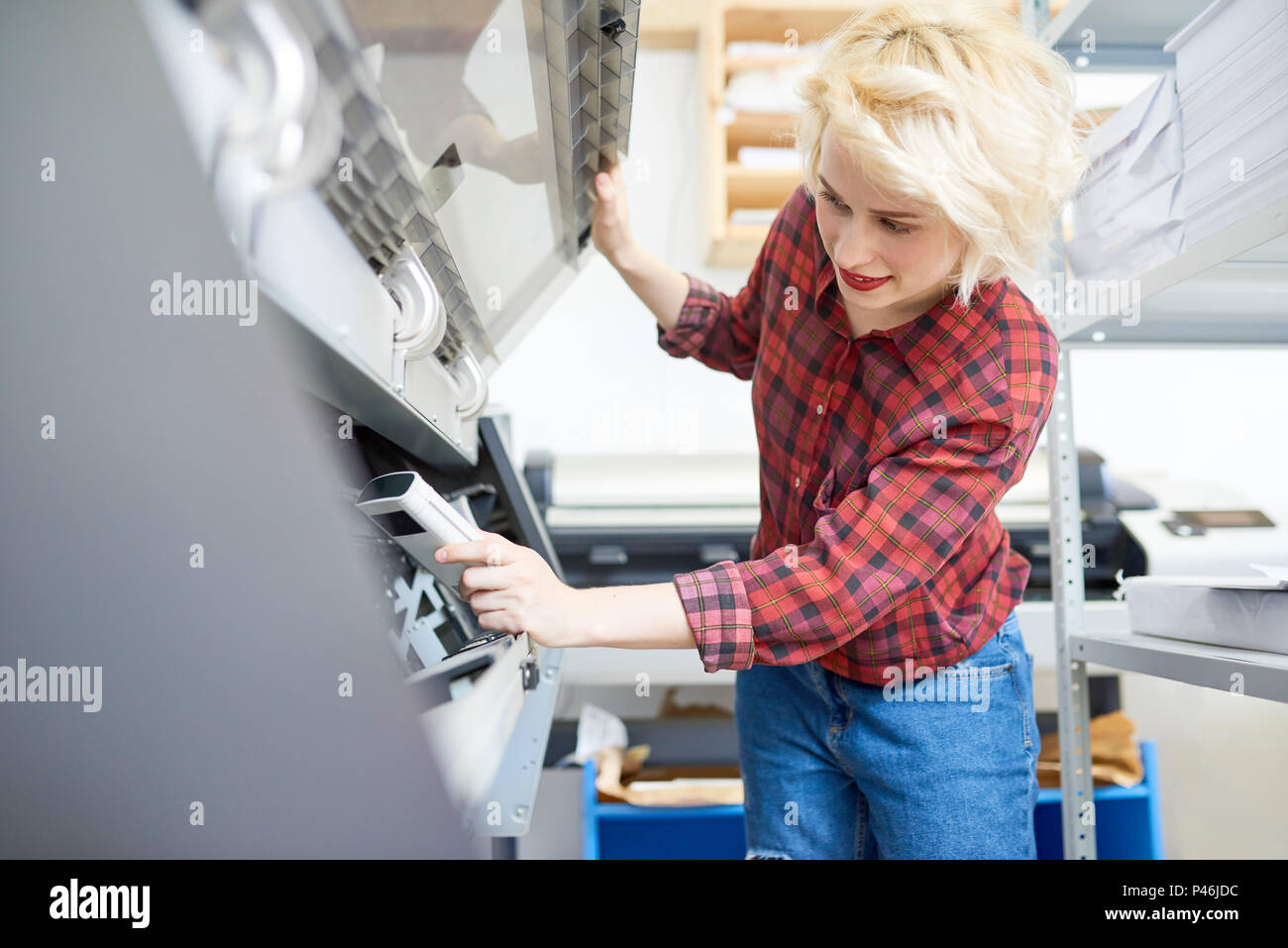 Young woman checking printer Stock Photo - Alamy Young woman checking printer Stock Photo - Alamy