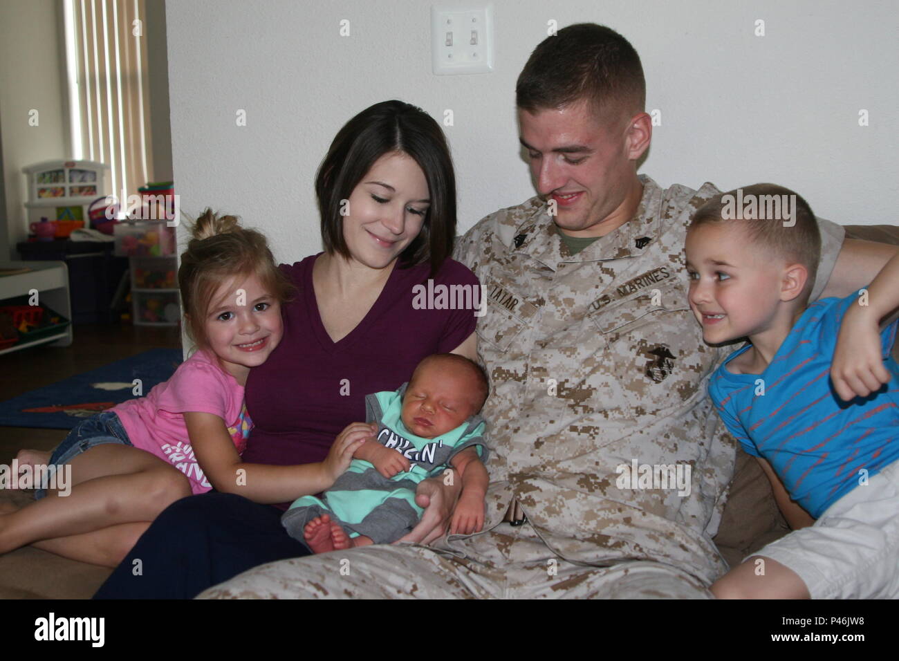 Sgt. Matthew Tatar and his wife Tiffany in their home with their older ...