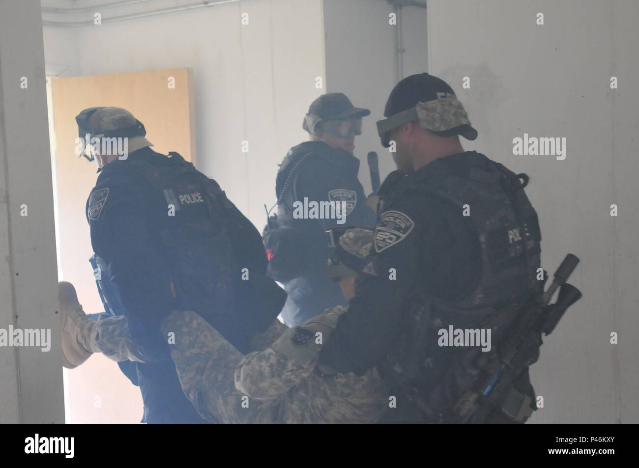 Members of the Evansville, Ind., SWAT team carry an injured hostage out ...
