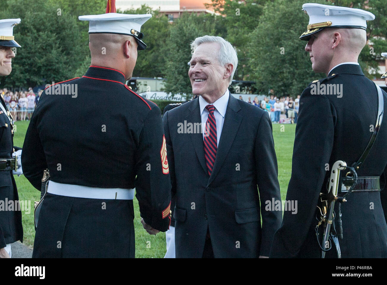 The Honorable Mr. Ray Mabus, secretary of the Navy, shakes hands with a ...