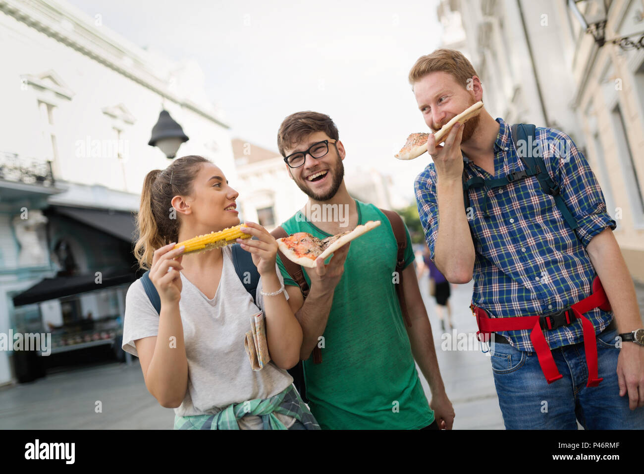 Happy people eating fast food in city Stock Photo - Alamy