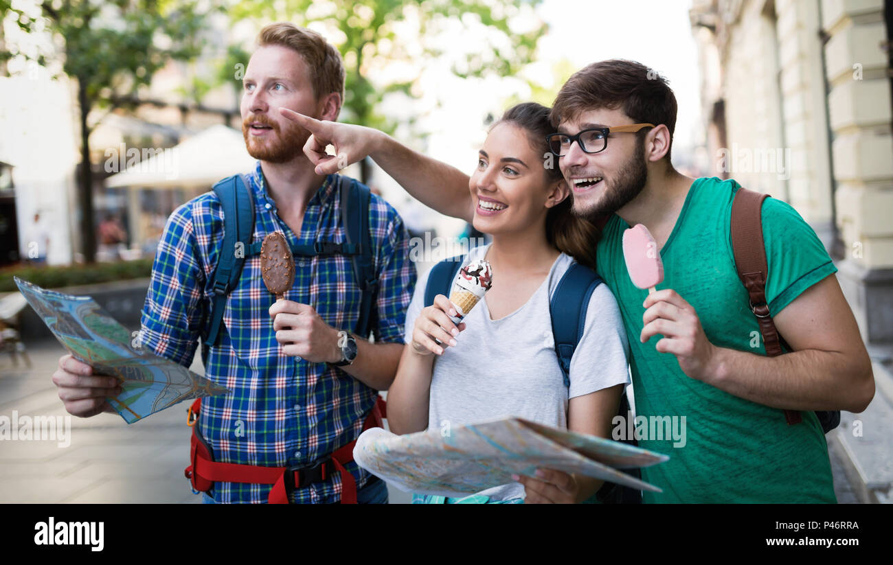 Tourist friends discovering city on foot Stock Photo - Alamy