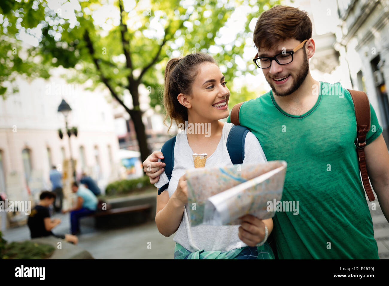 Tourist friends discovering city on foot Stock Photo - Alamy