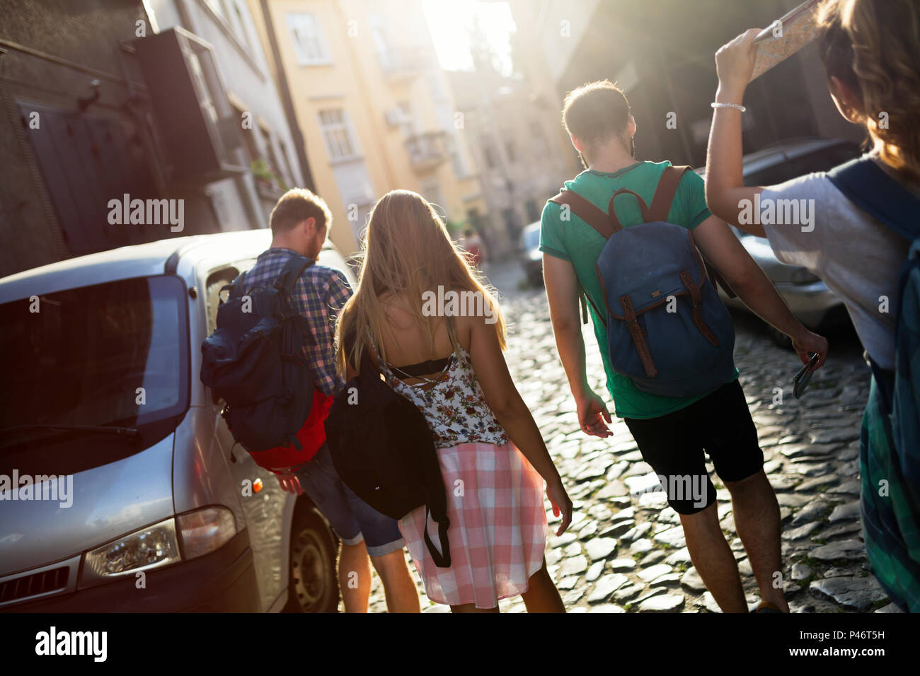 Tourist friends discovering city on foot Stock Photo - Alamy