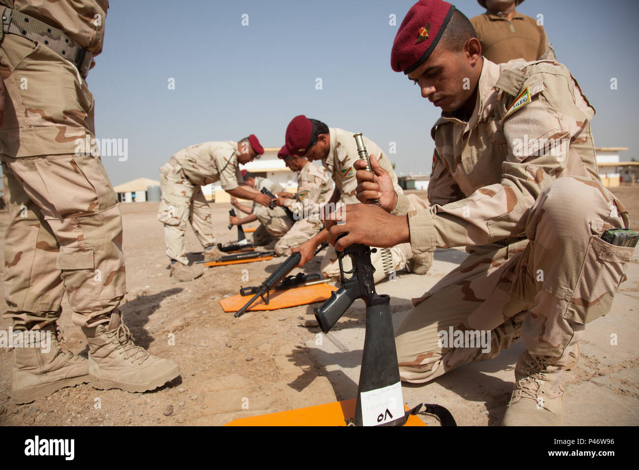 Iraqi soldiers disassemble their M16 rifles during a junior leadership ...