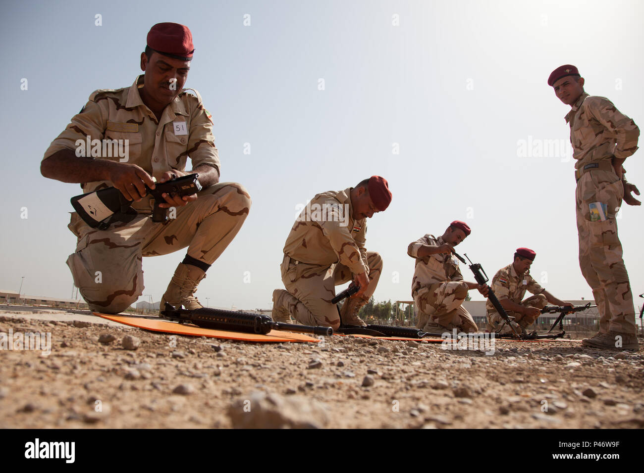 Iraqi soldiers disassemble their M16 rifles during a junior leadership ...