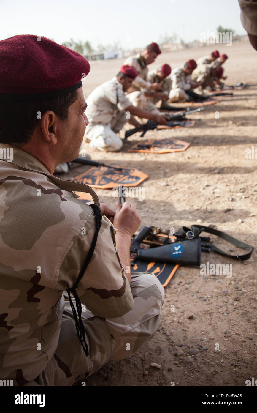 Iraqi soldiers disassemble their M16 rifles during a junior leadership ...