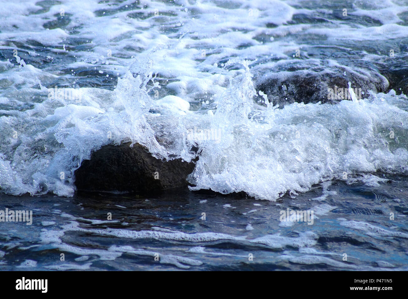 Wave hit stone Stock Photo - Alamy